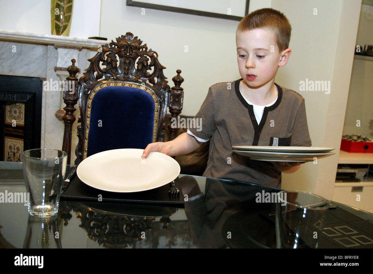 young boy helping to set table Stock Photo - Alamy
