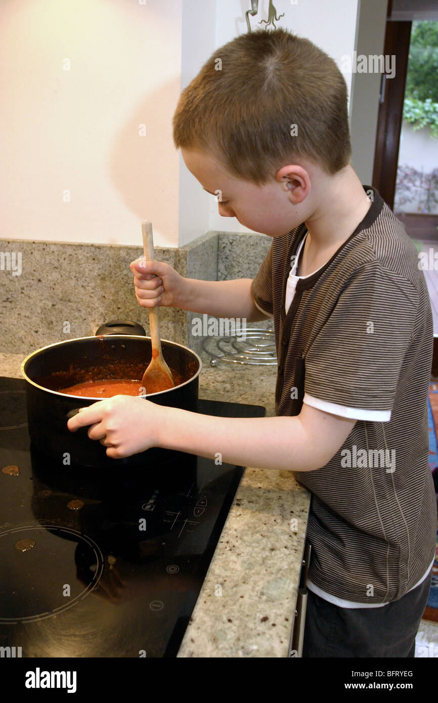 young child cooking over a stove Stock Photo - Alamy