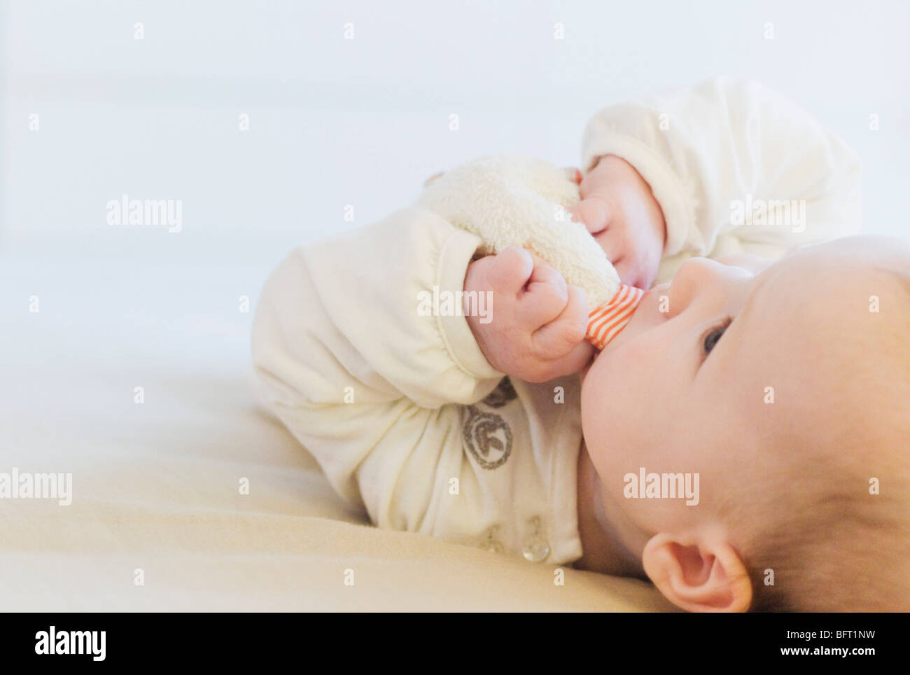 Baby Chewing on Toy Stock Photo - Alamy