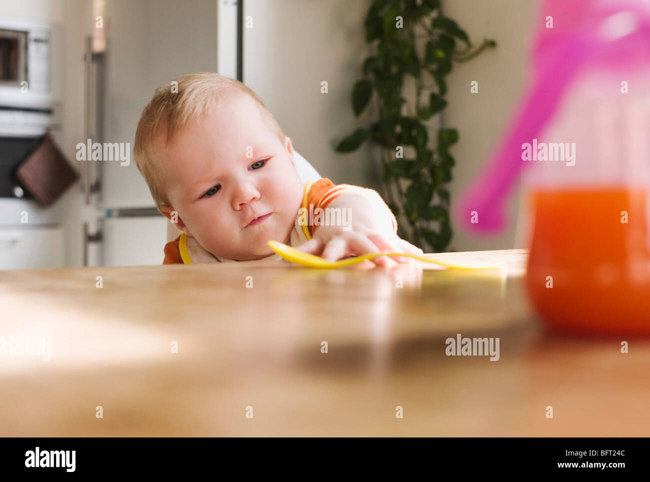 Baby Reaching For Spoon Stock Photo - Alamy