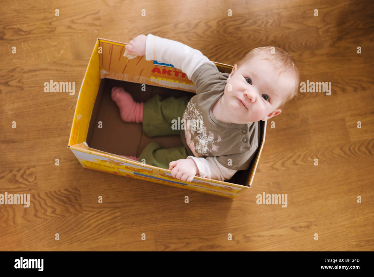 Baby Sitting in a Box Stock Photo - Alamy