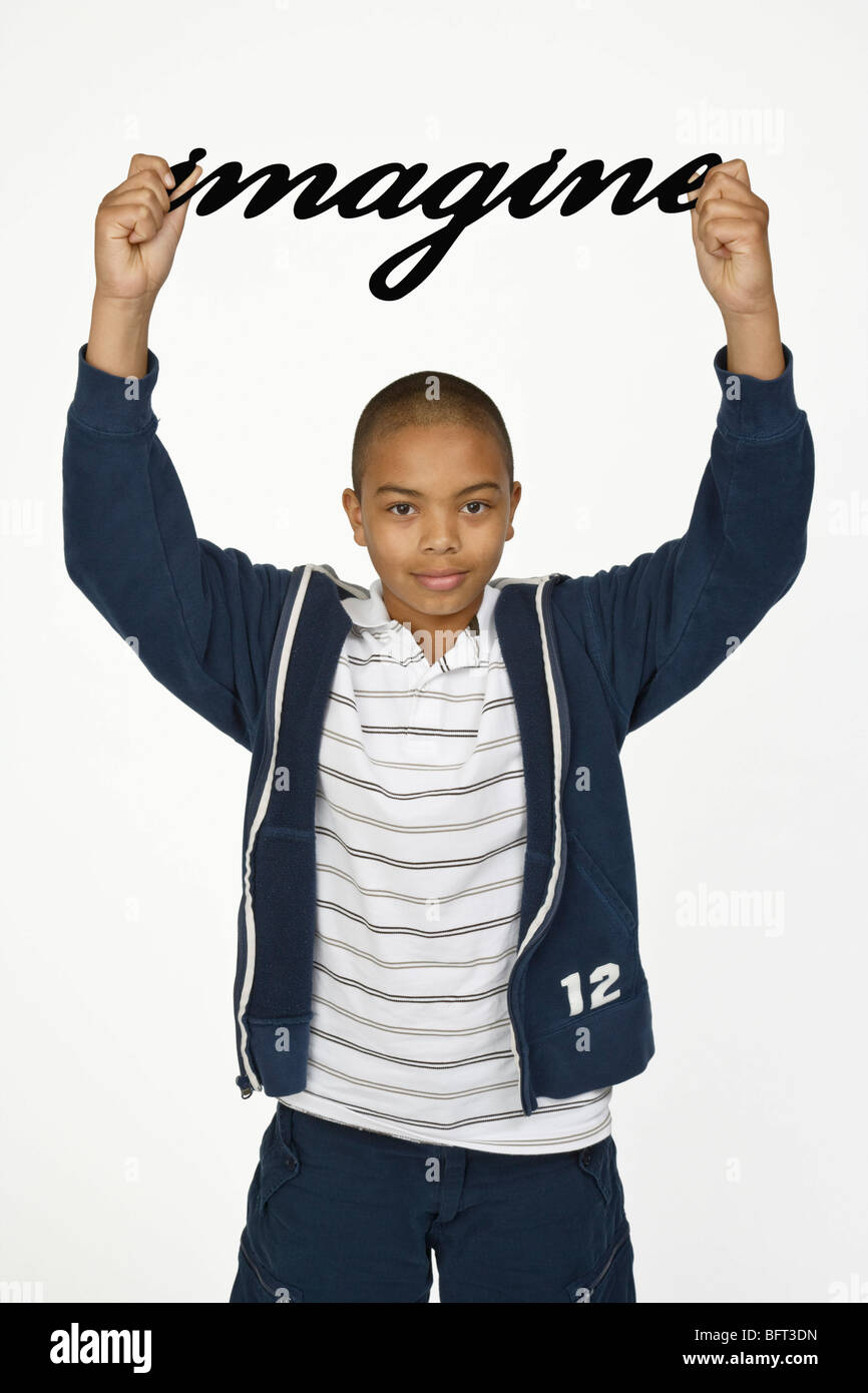 Boy Holding Imagine Sign Stock Photo - Alamy