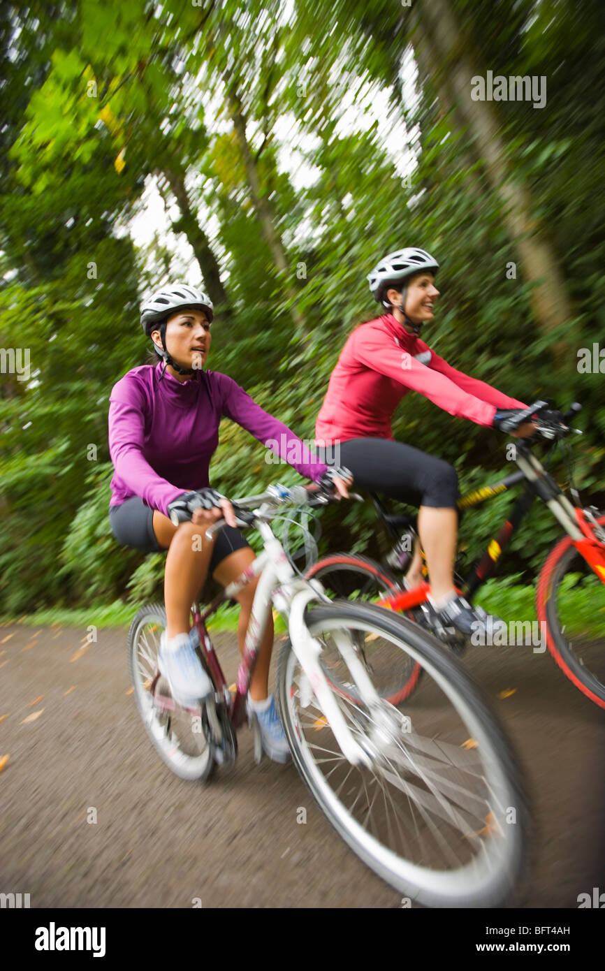 Women Riding Bikes in Forest Stock Photo - Alamy