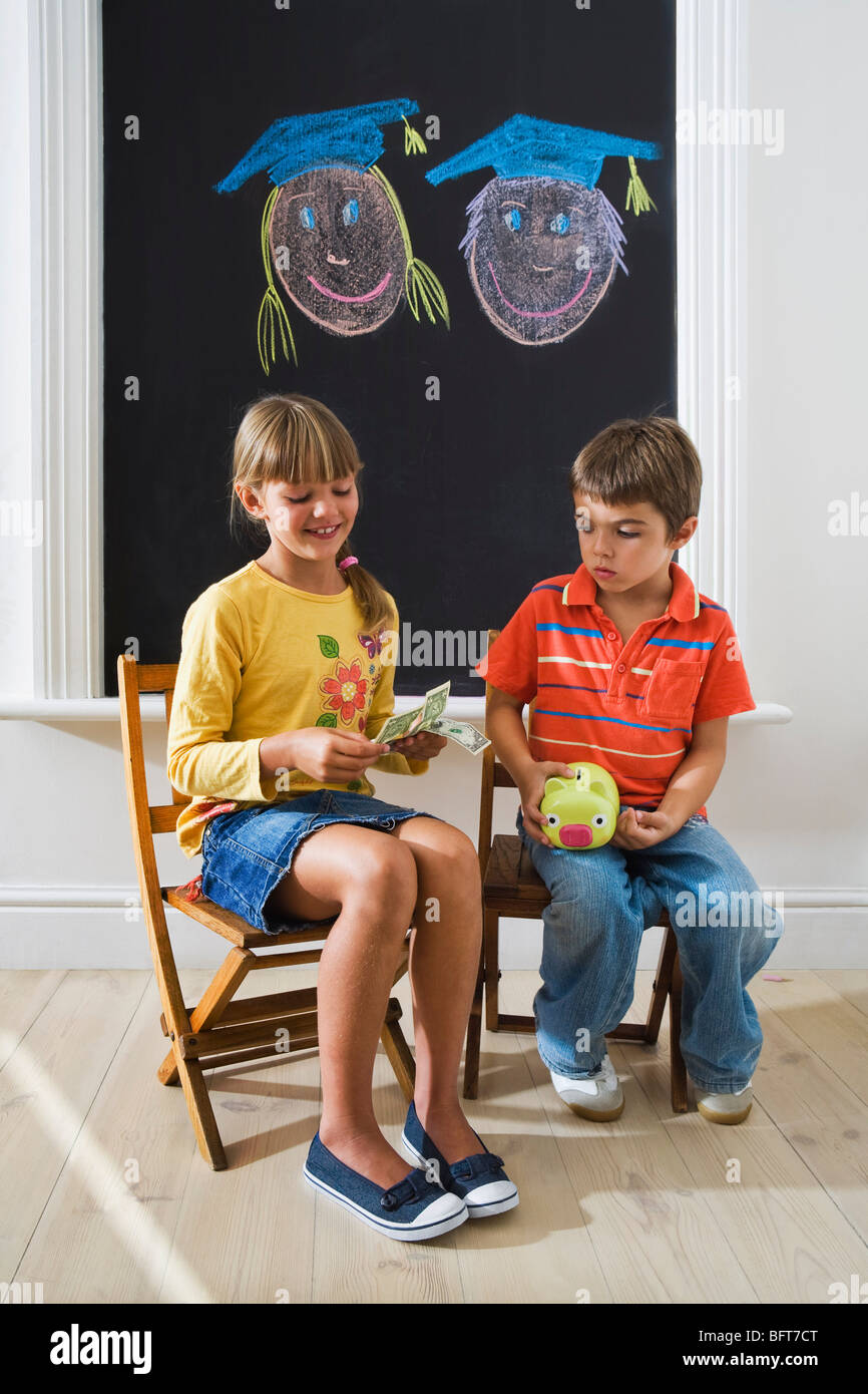 Boy and Girl Counting Money for College Fund Stock Photo - Alamy