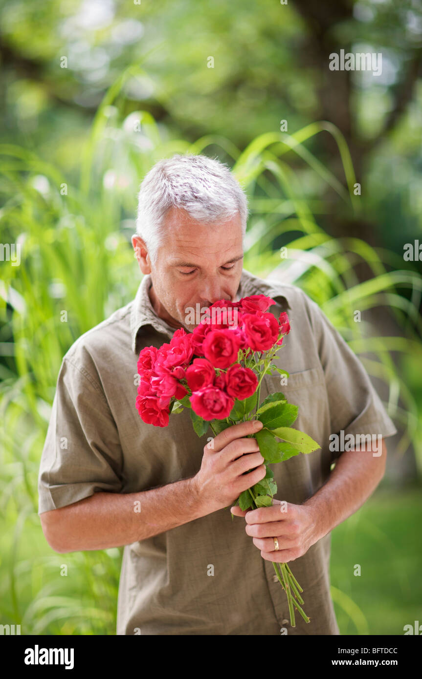 Mature gentleman holding rose flower hi-res stock photography and ...