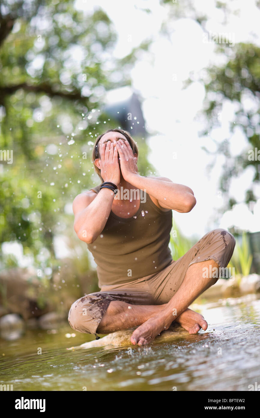 Man sitting in a river Stock Photo - Alamy
