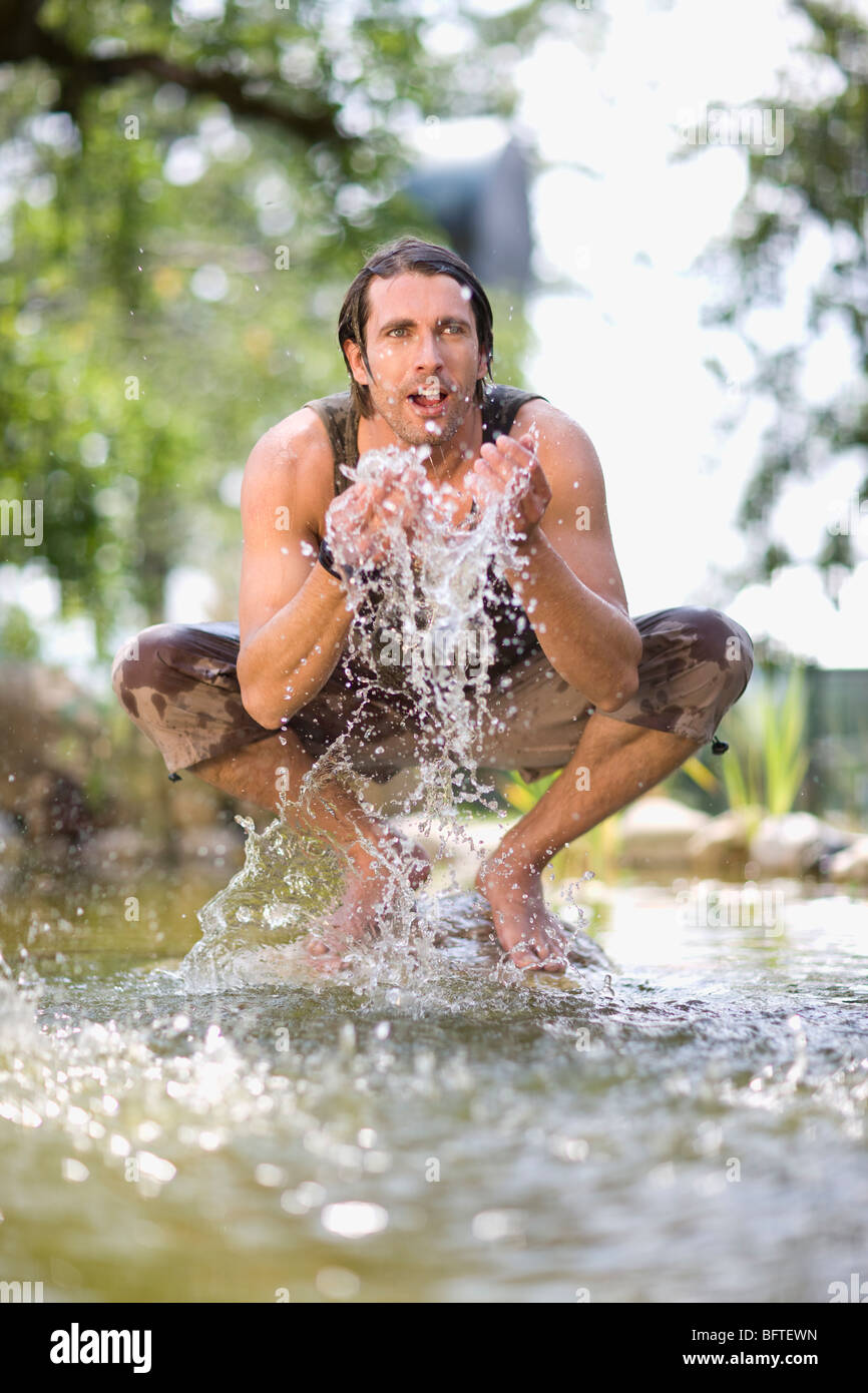 Man sitting in a river Stock Photo - Alamy
