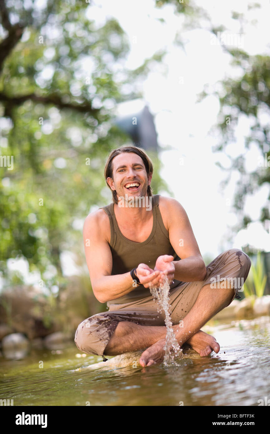Man sitting in a river Stock Photo - Alamy