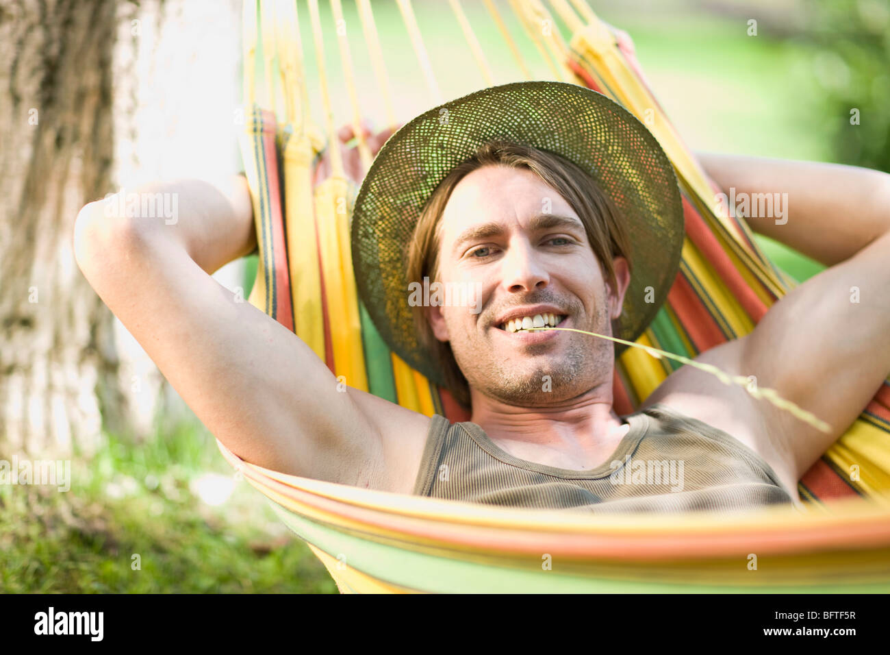 Man sleeping in a hammock Stock Photo - Alamy