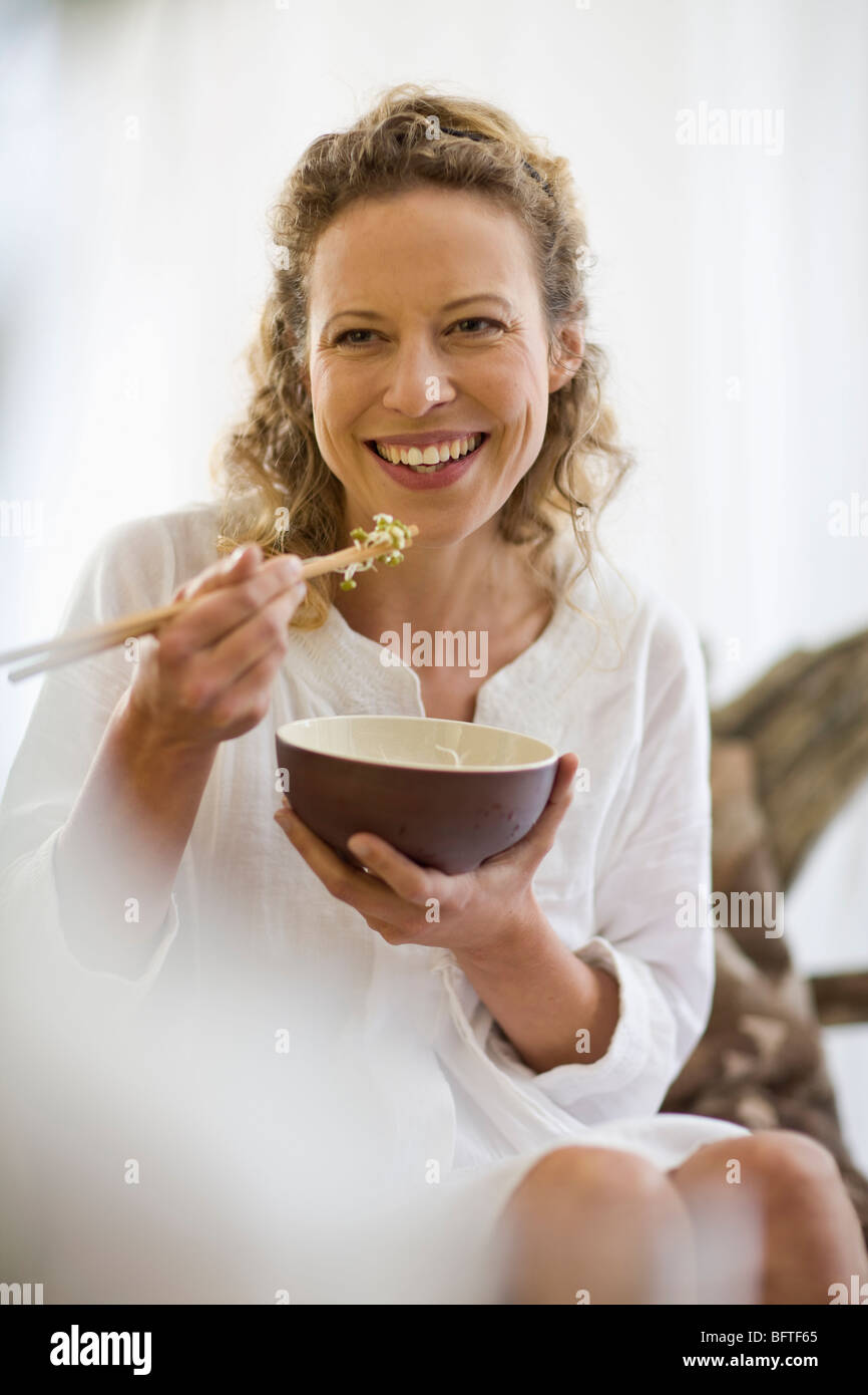 middle-aged woman eating healthy food Stock Photo - Alamy