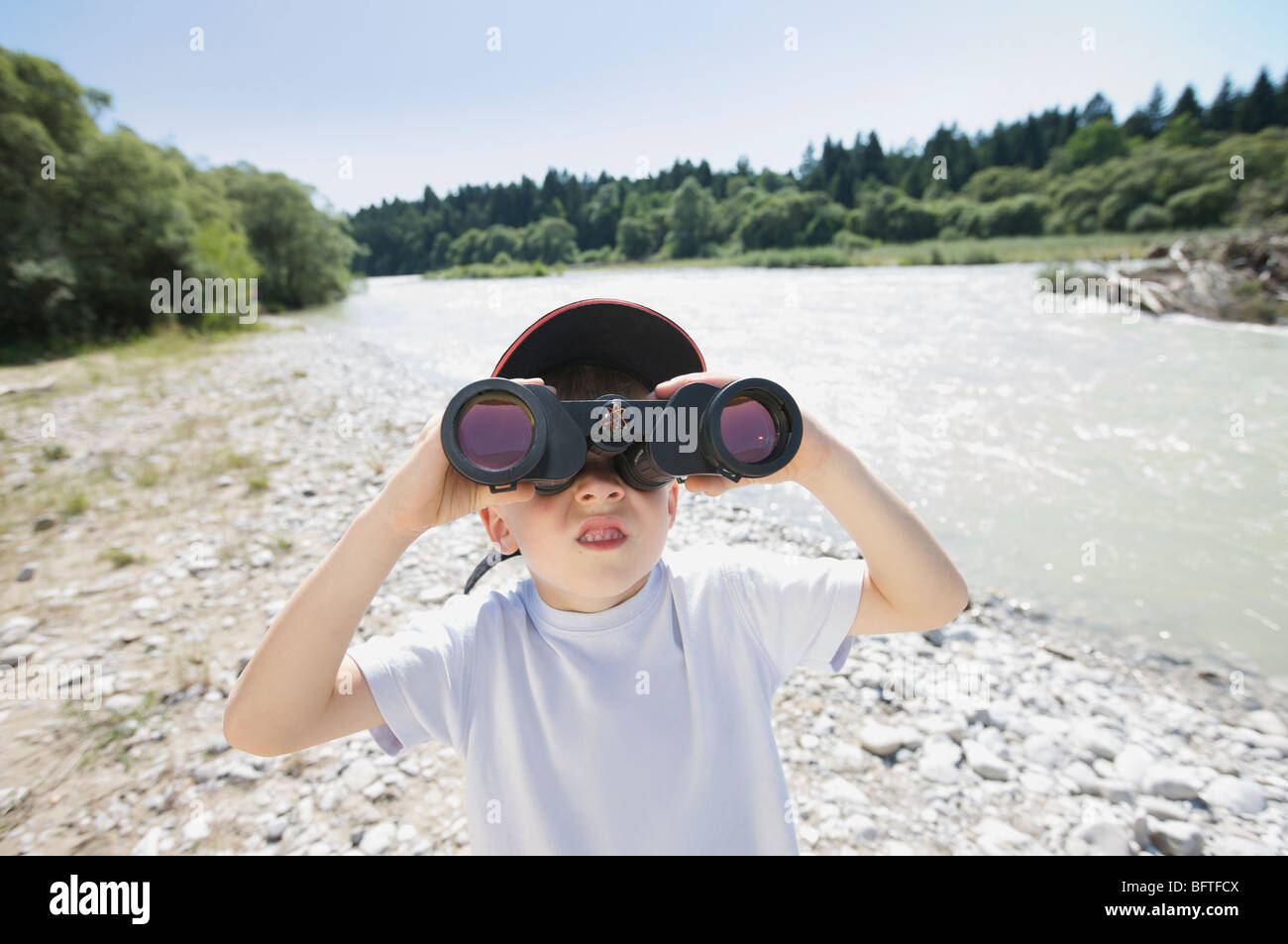 boy looking through field glasses Stock Photo - Alamy