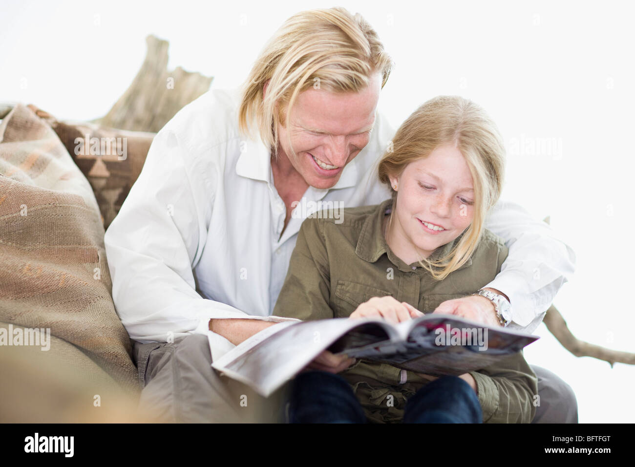 father and daughter reading a magazine Stock Photo - Alamy