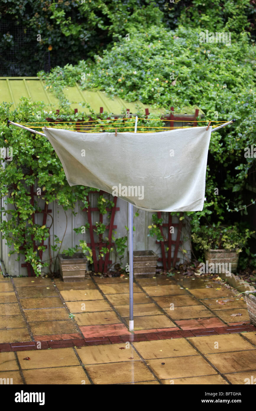 Washing line with a towel blowing in the wind but will never dry as it ...