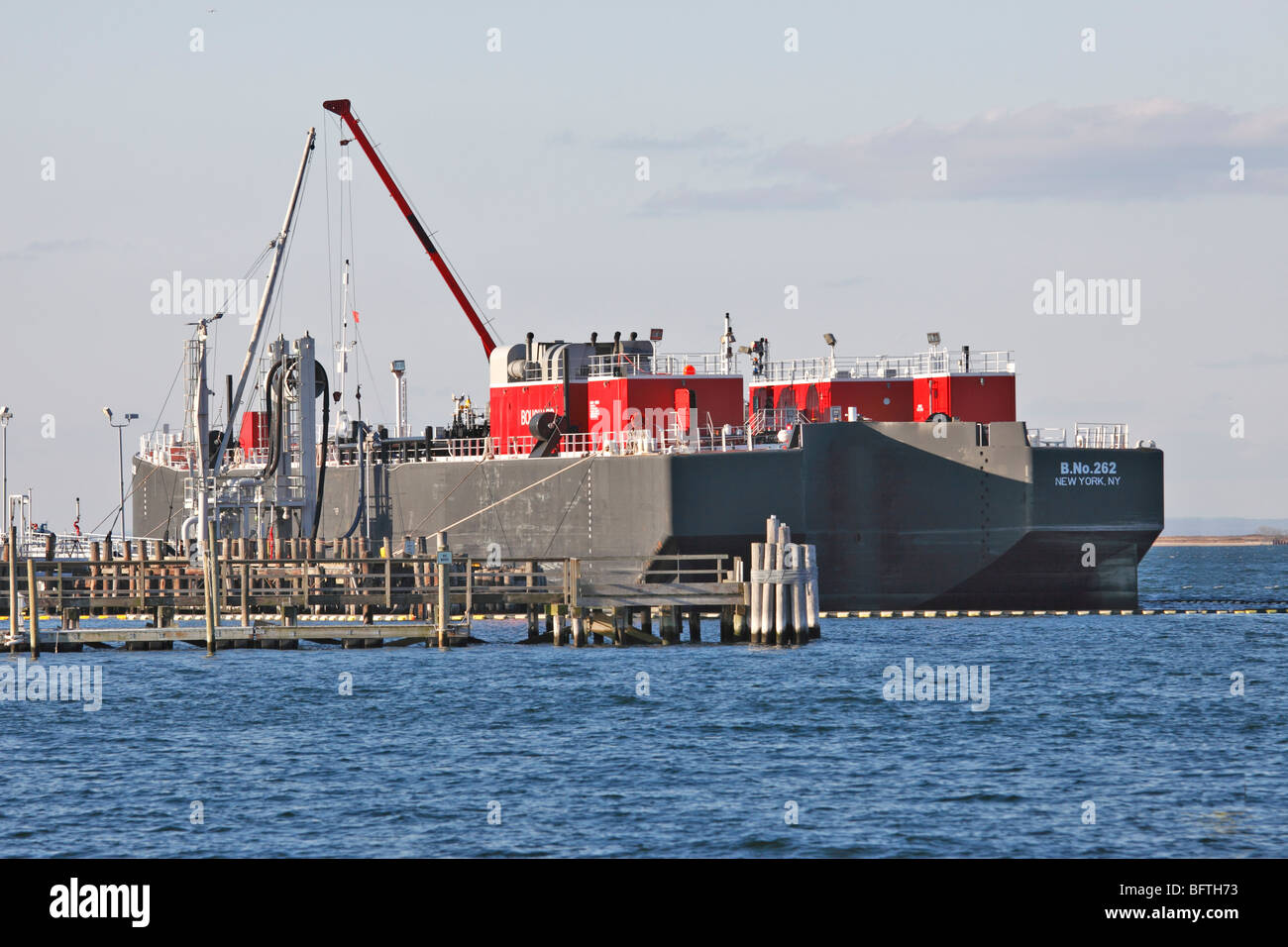 A double hulled oil tank barge unloads its cargo of of oil at power ...