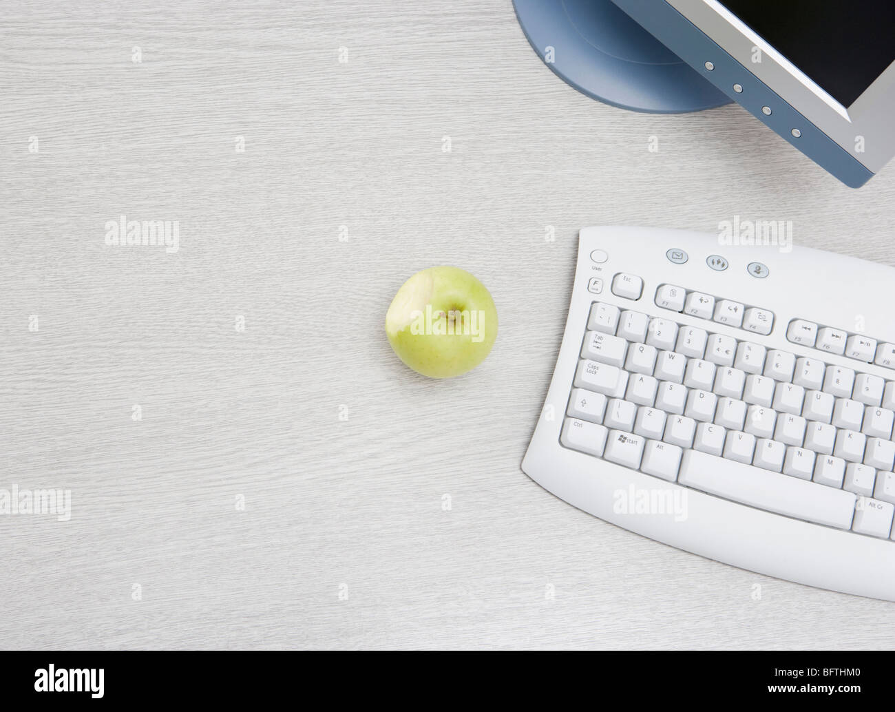 apple on desk by pc Stock Photo - Alamy