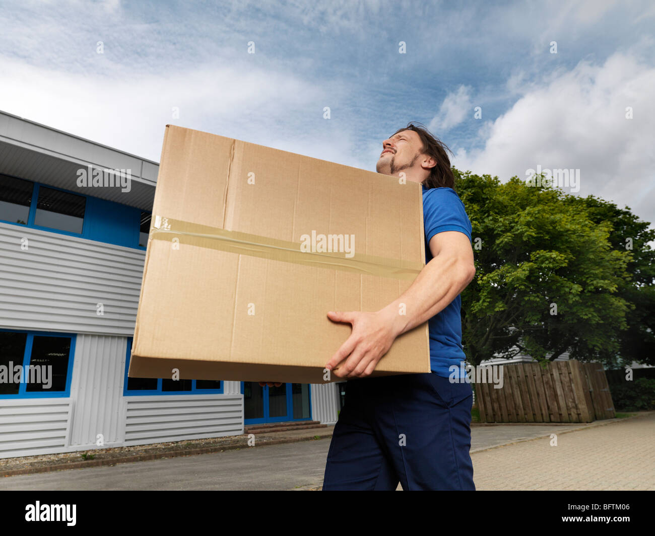 Man carrying heavy hi-res stock photography and images - Alamy