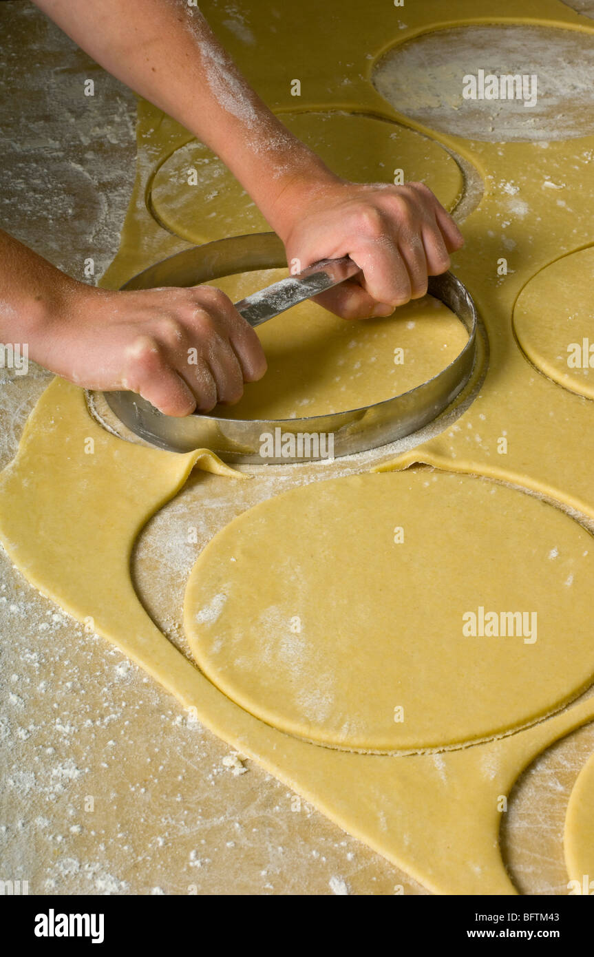 Pastry cutting by hand for commercial Yorkshire curd cheesecake ...