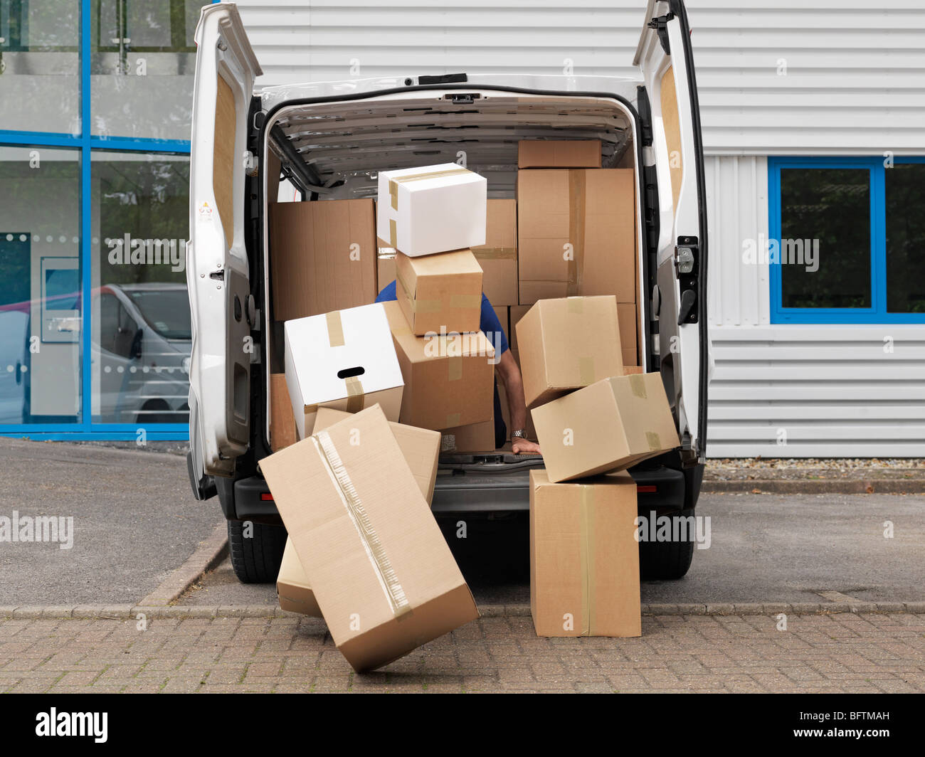 boxes falling from back of van Stock Photo - Alamy