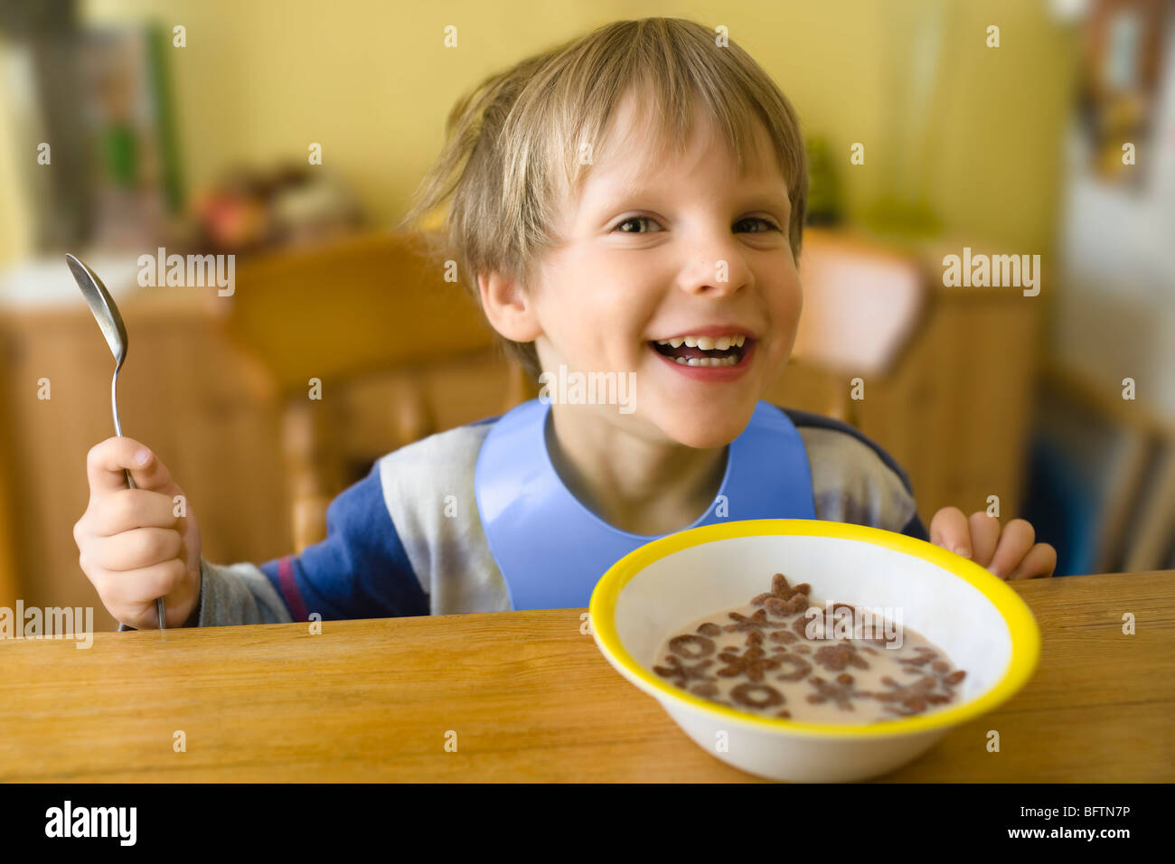 Boy Grinning at Breakfast Stock Photo - Alamy