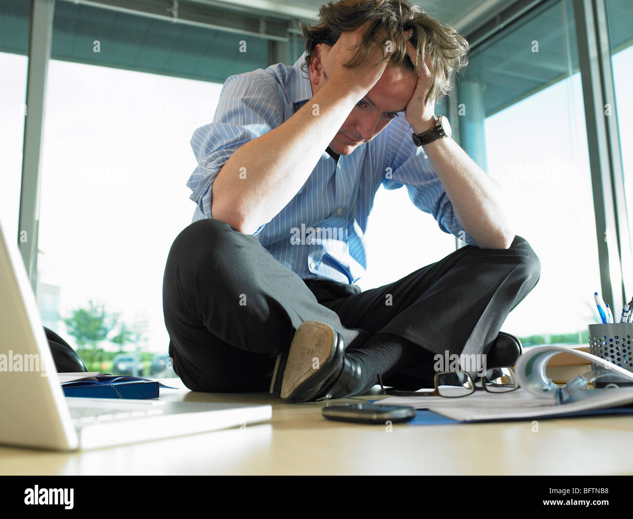 Man on his desk, thinking Stock Photo - Alamy