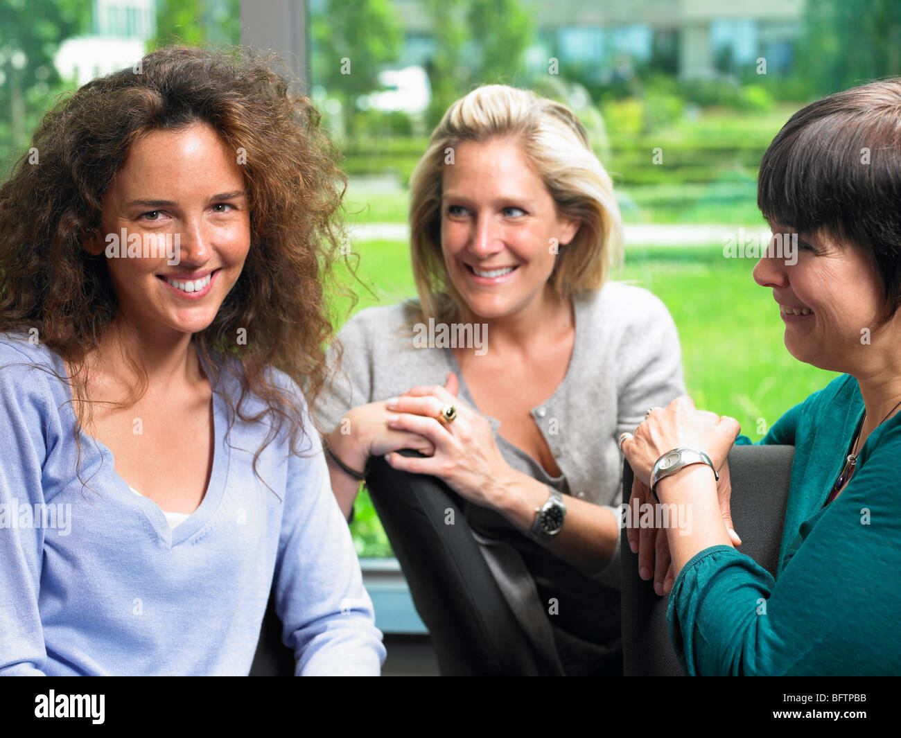 Women looking at camera, smiling Stock Photo - Alamy