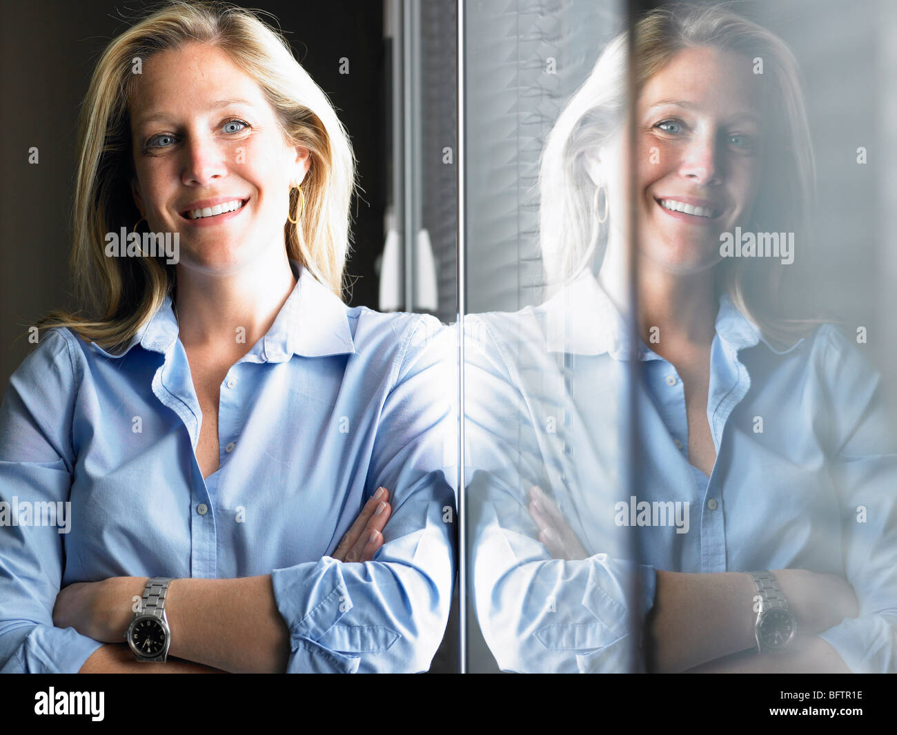 Woman against window, smiling Stock Photo - Alamy