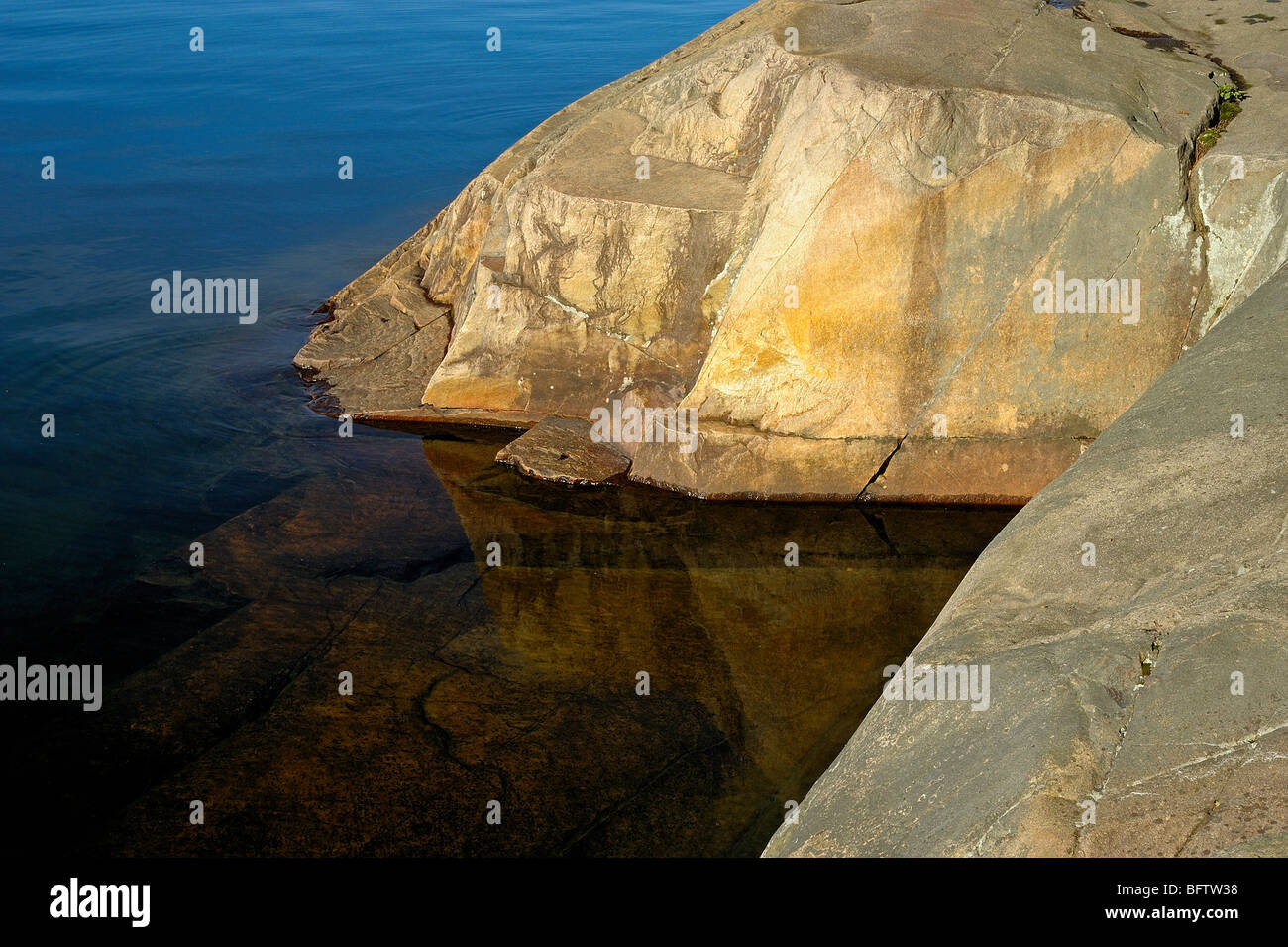Granite rock outcrops along shore of George Lake, Killarney Provincial ...