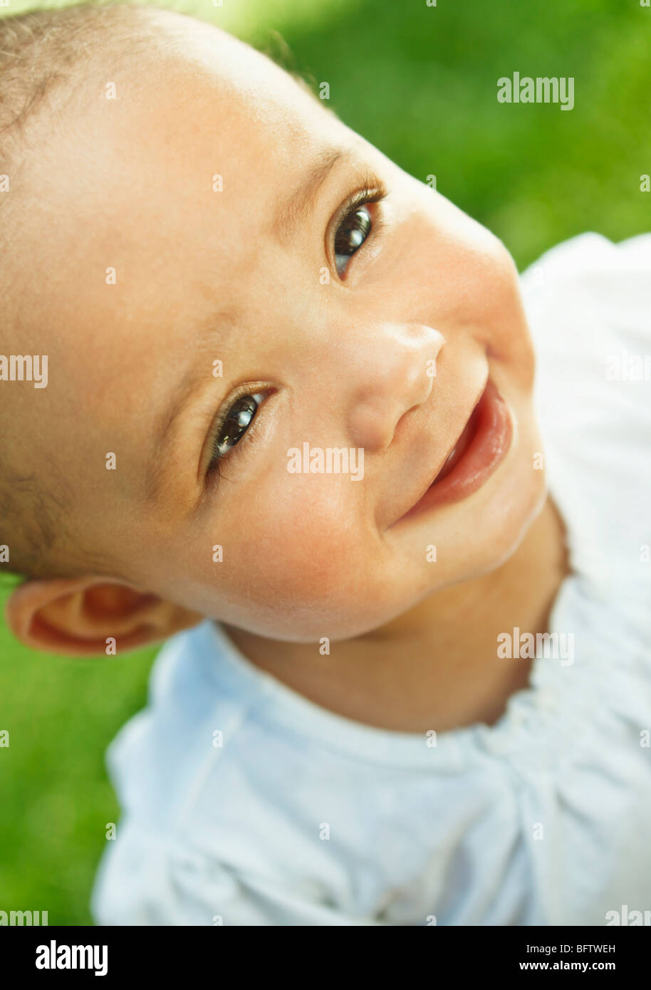 Baby smiling and looking up Stock Photo - Alamy