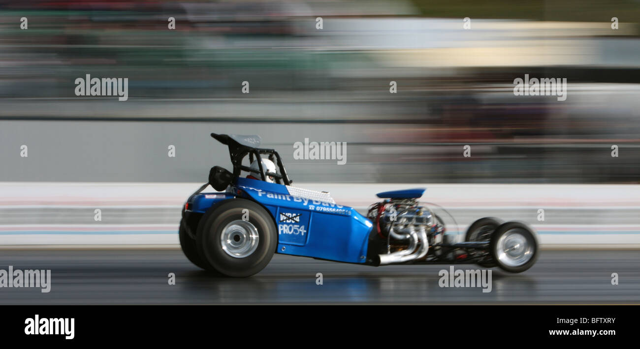 A hot rod dragster speeding down the strip at Santa Pod Stock Photo - Alamy