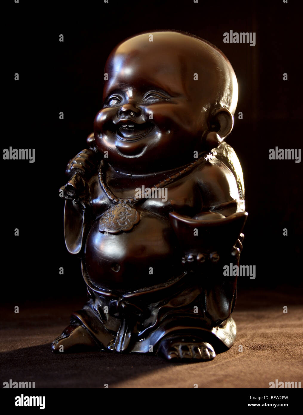 Smiling Buddha brings light to give you some happiness Stock Photo - Alamy