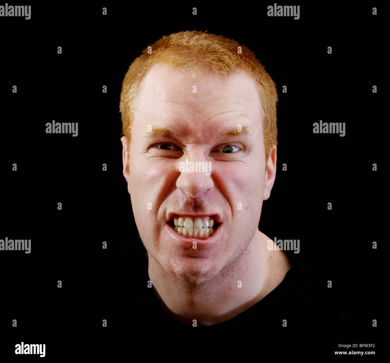 Very angry man on crisp black background Stock Photo - Alamy