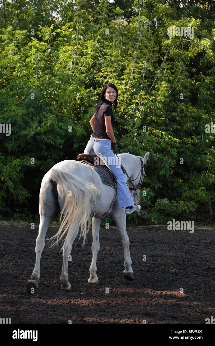 Mid adult woman riding a horse in woods Stock Photo - Alamy