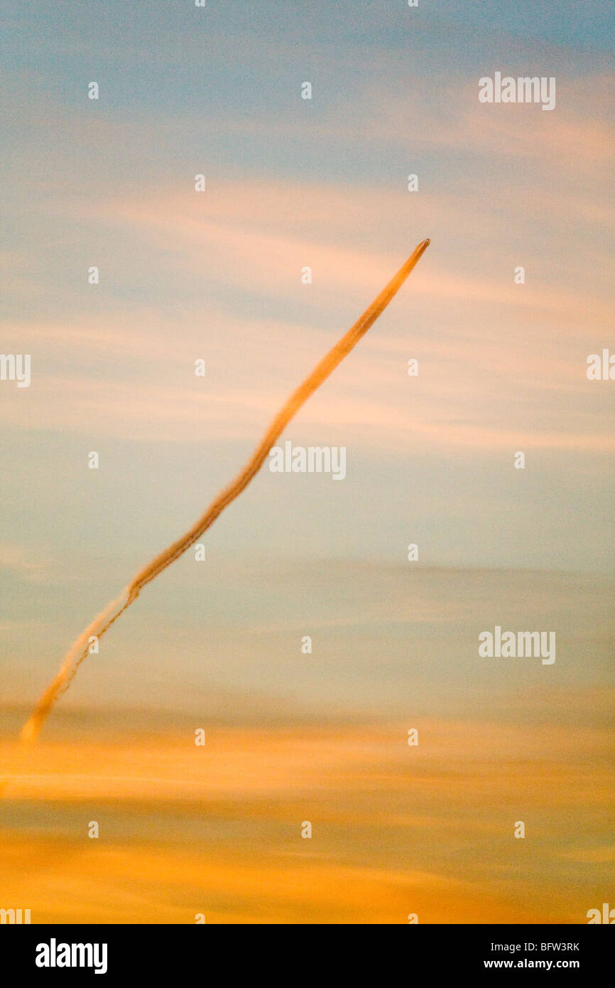 Aircraft Contrails in Sunset Sky Stock Photo - Alamy