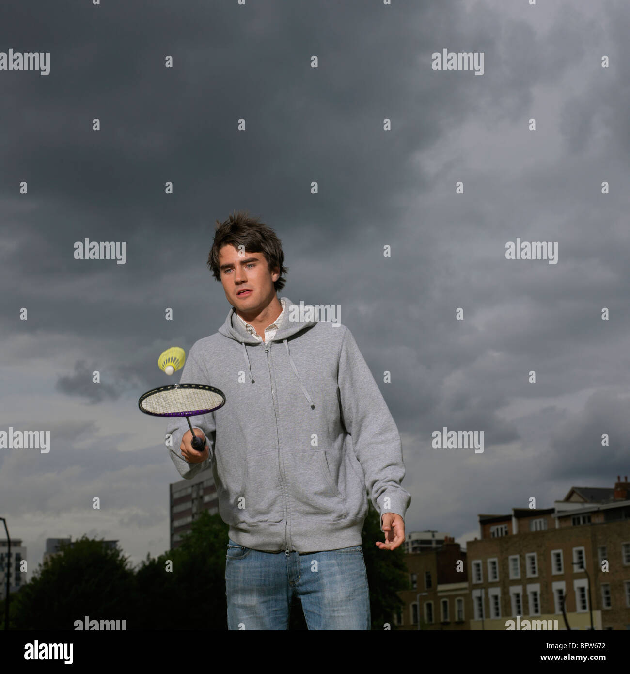 Young man with badminton racket Stock Photo - Alamy