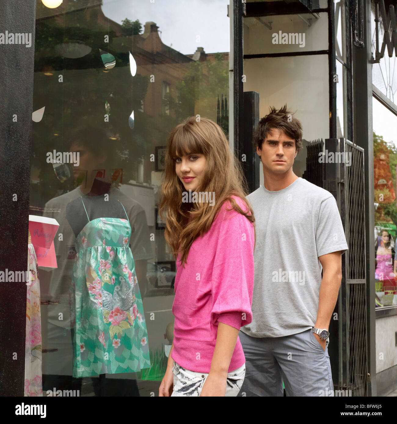 Young woman and man outside a shop Stock Photo - Alamy