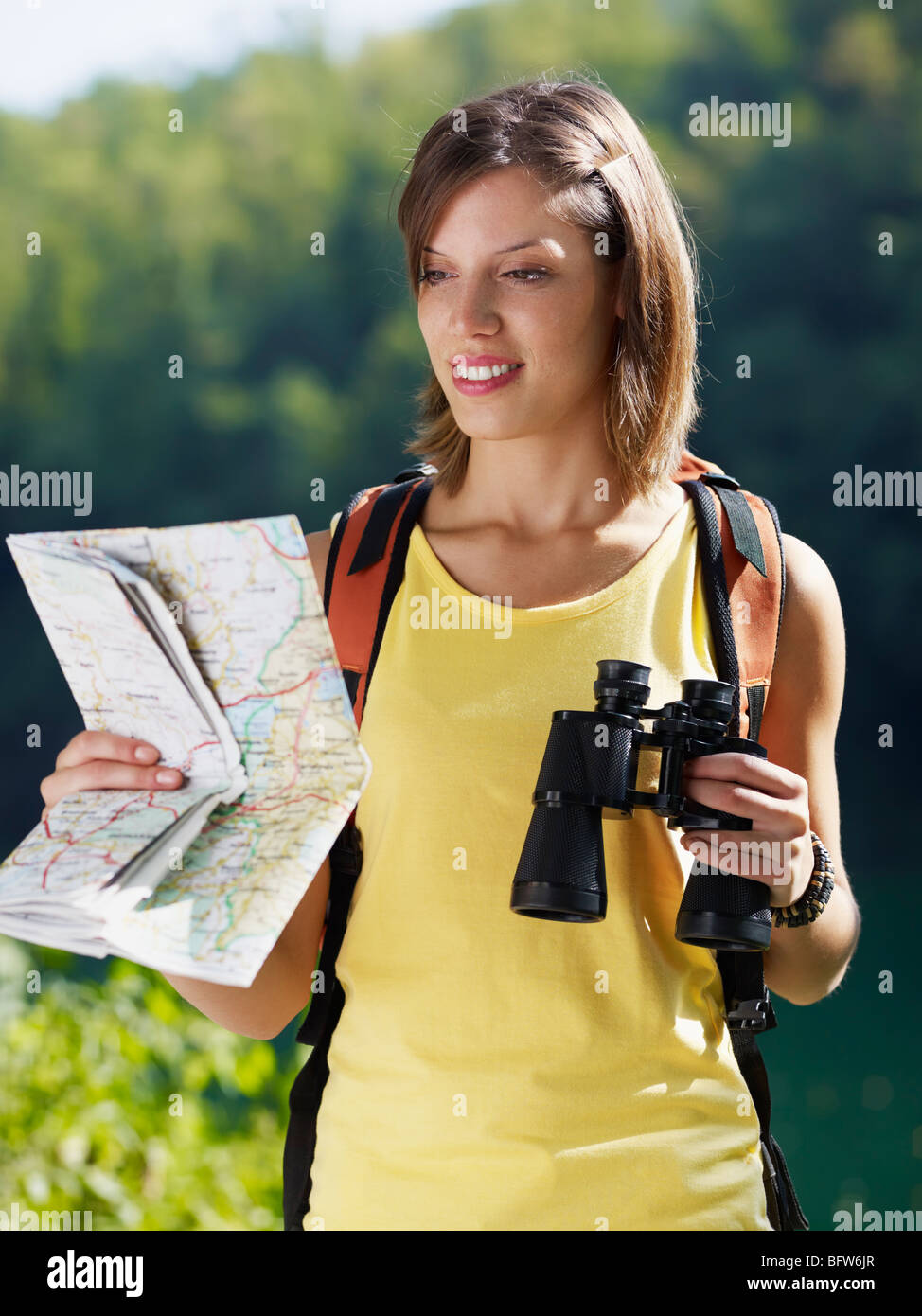 young hiker holding map and binoculars Stock Photo - Alamy