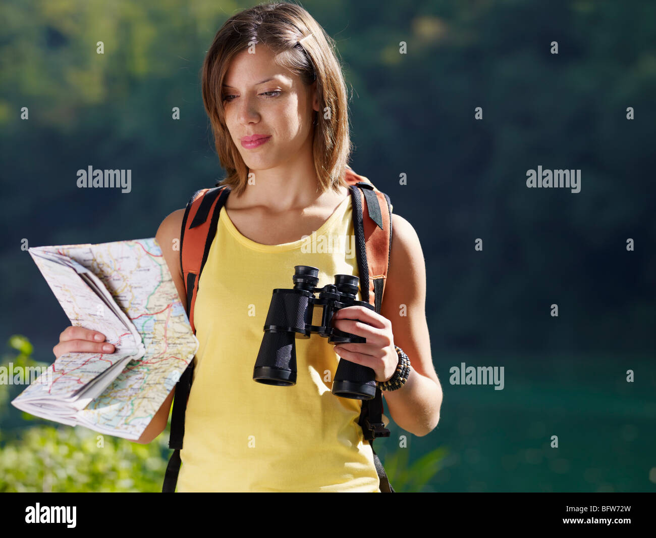 young hiker holding map and binoculars Stock Photo - Alamy