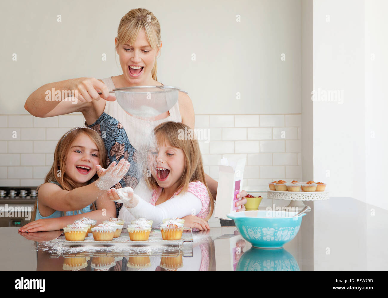 Two girls and a mum baking Stock Photo - Alamy
