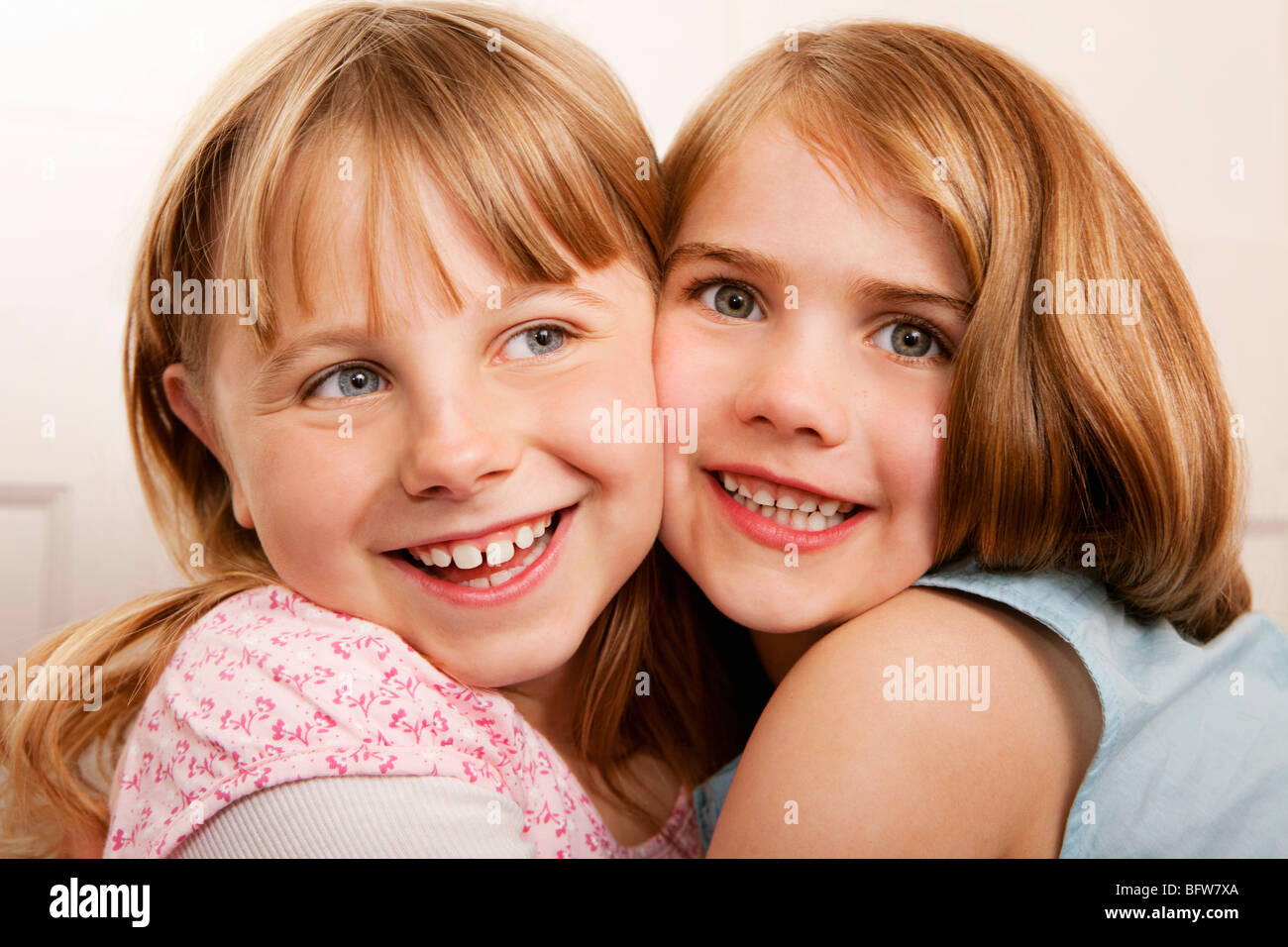 Portrait of two girls hugging Stock Photo - Alamy