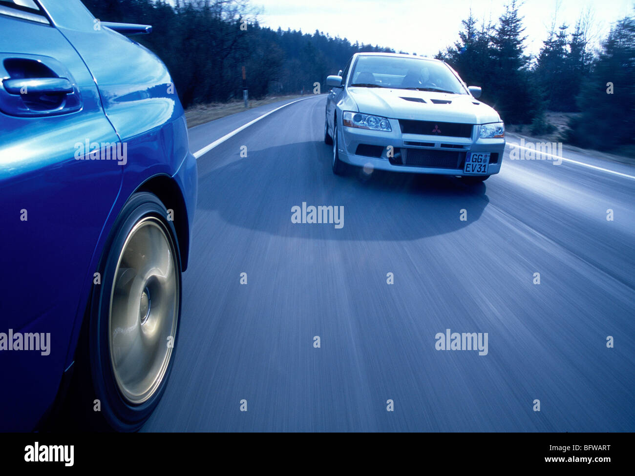 Subaru WRX (blue) Mitsubishi EVO7 ( silver) 2002 Stock Photo - Alamy
