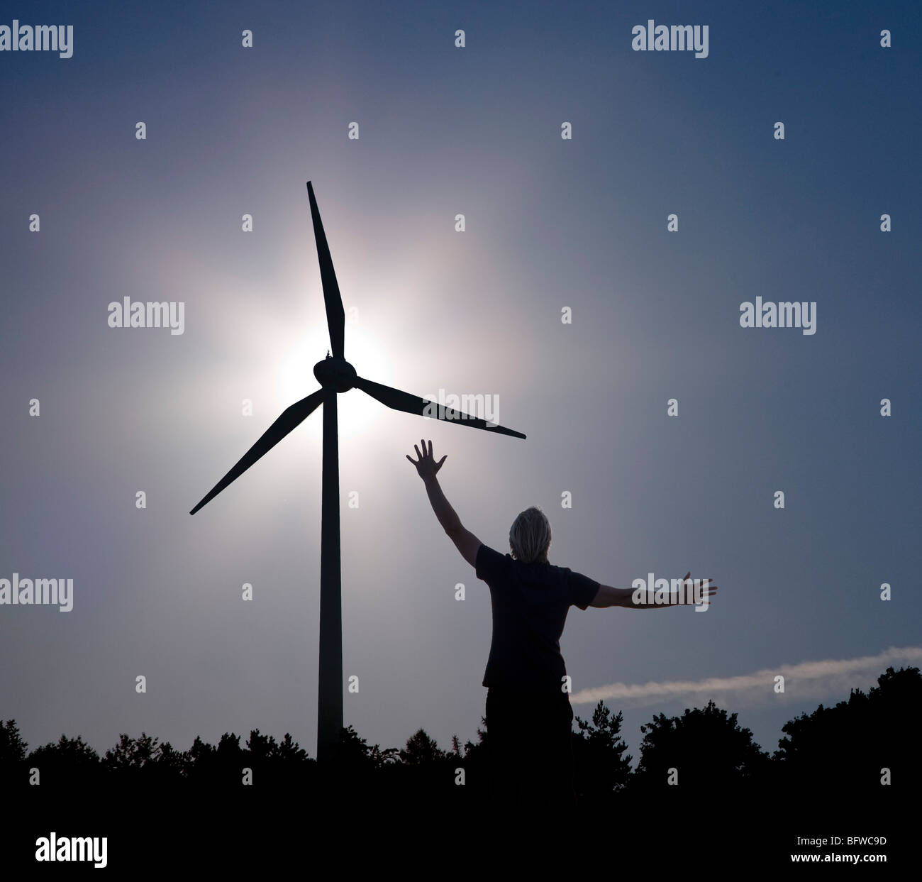 man raising arms at sun and Wind Turbine Stock Photo - Alamy