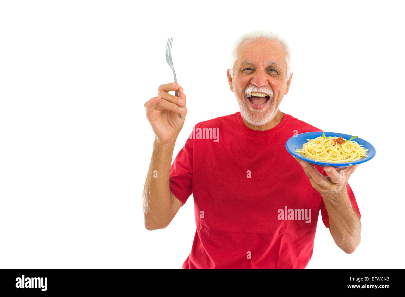 Hungry Senior holding a dish with spaghetti Stock Photo - Alamy