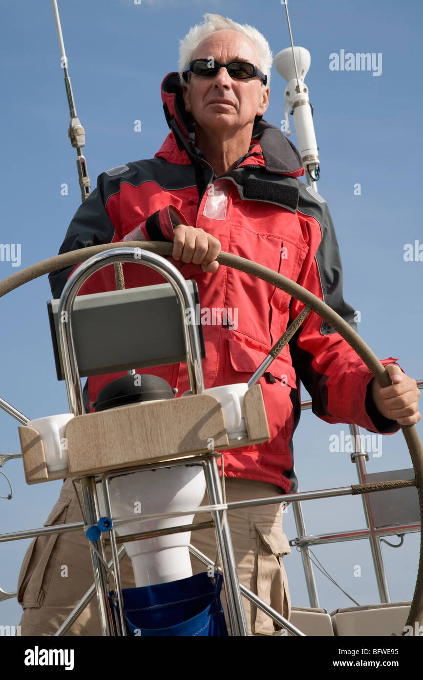 Mature man sailing yacht Stock Photo - Alamy