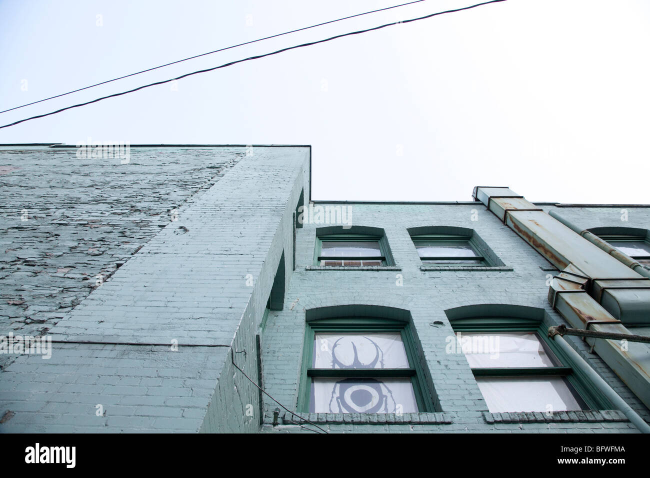 looking up at a green brick building Stock Photo - Alamy