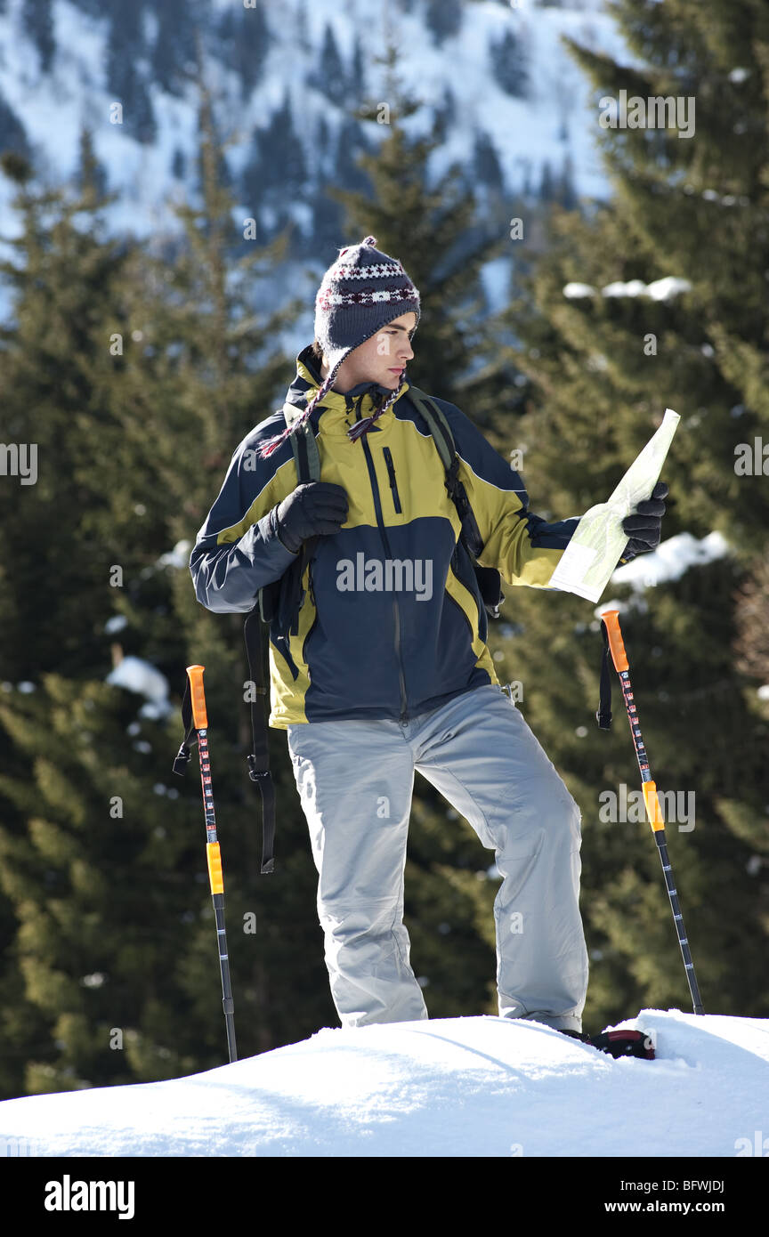 Young man in snow hiking Stock Photo - Alamy