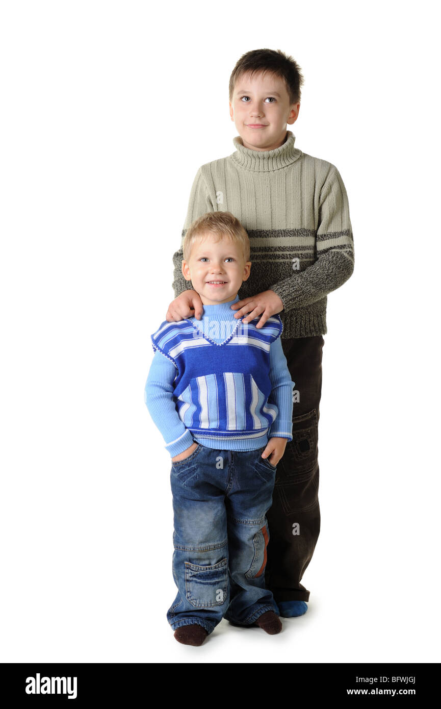 Two brothers. Age of 3 and 7 years. It is isolated on a white ...