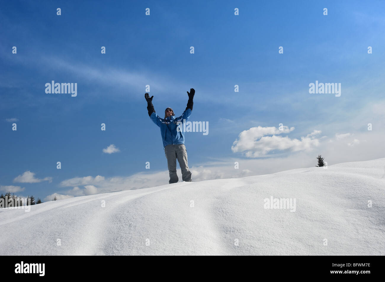 Young man in winter scene with snow, arms outstretched Stock Photo - Alamy