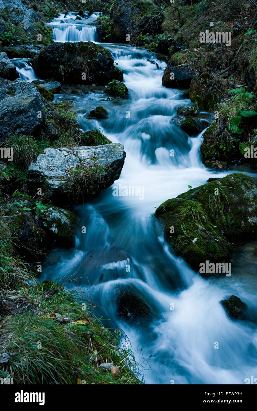 blue creek with green stones around Stock Photo - Alamy