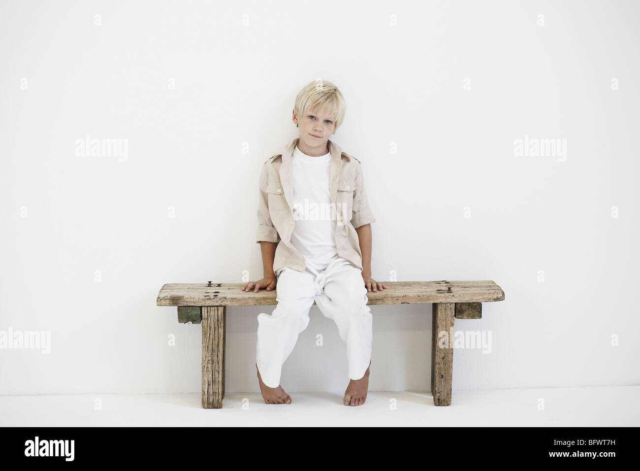 Portrait of young boy on a bench Stock Photo - Alamy