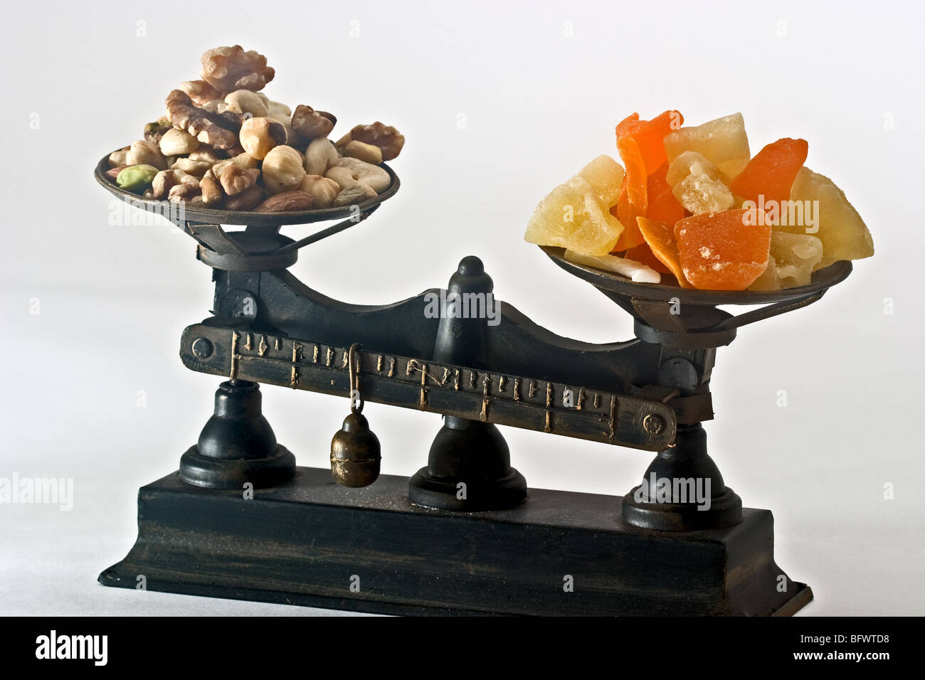 Balance scale with a pile of cut fruit on one side and a pile of mixed ...